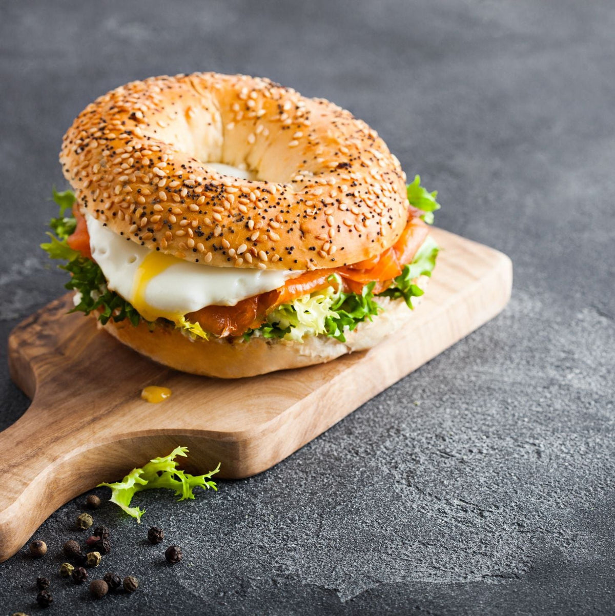 Open bagel brunch with smoked Coho salmon and tomato salad