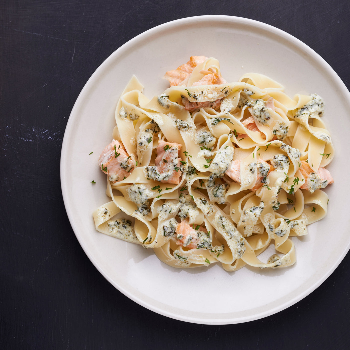 Creamy pasta with salmon cubes and smoked salmon