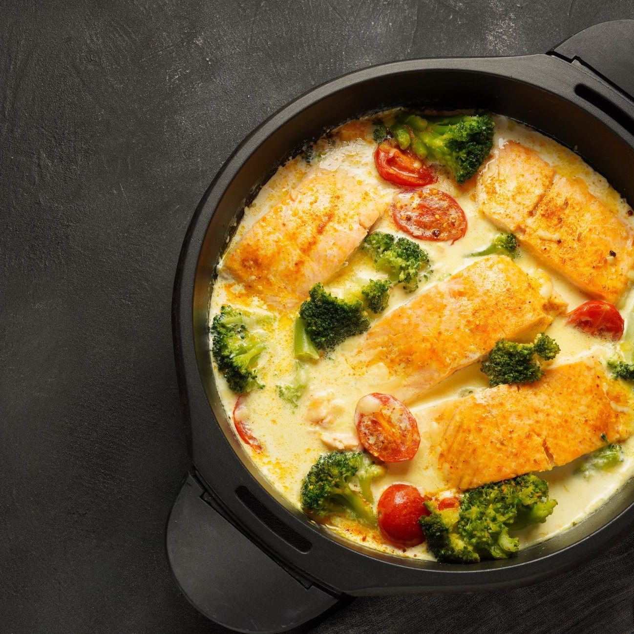 Pan-fried salmon steak with broccoli tops