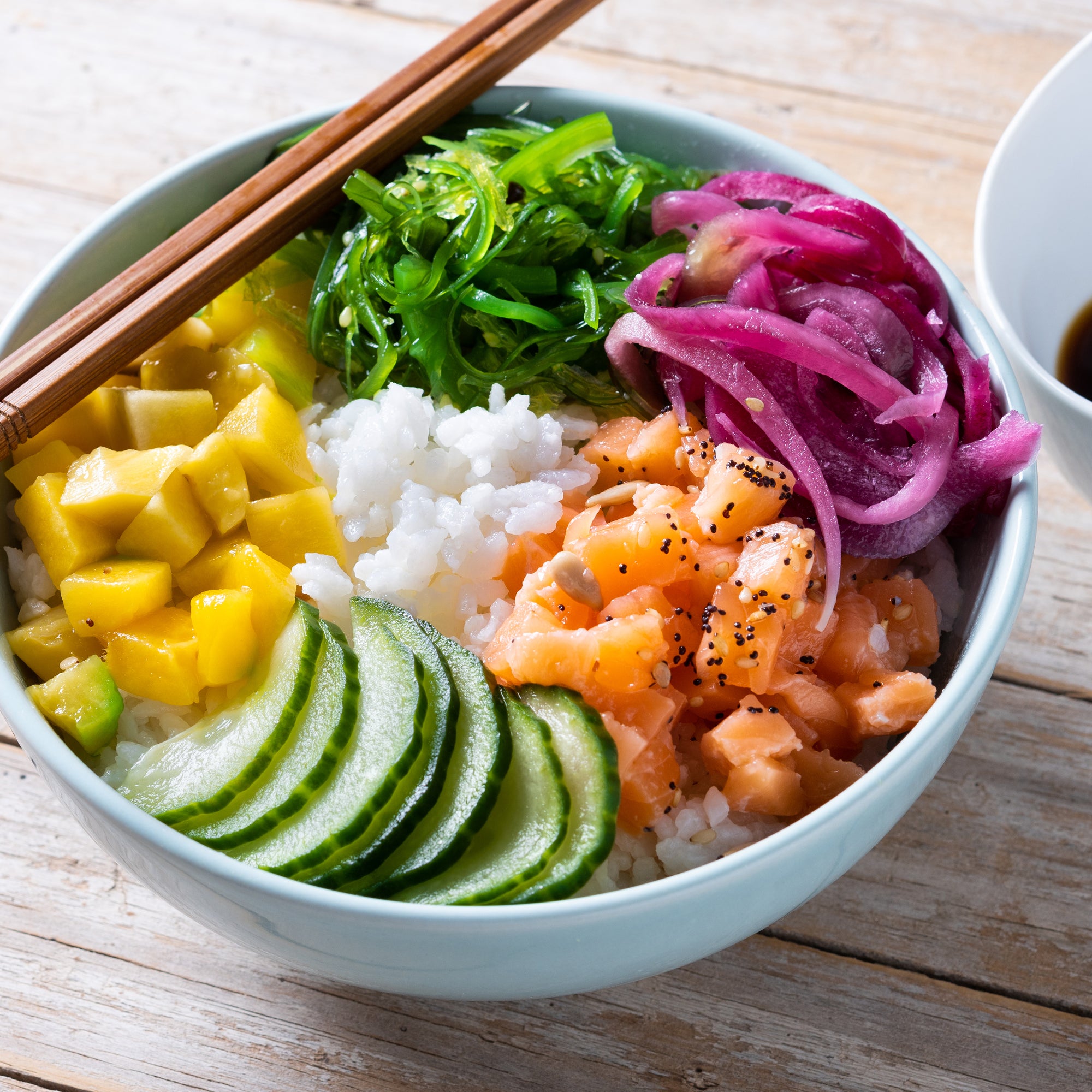 Poke bowl with salmon cubes and smoked salmon